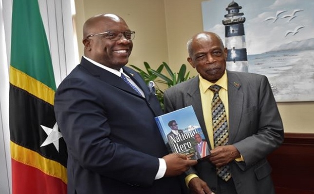 SKNVibes | Sir Kennedy Simmonds presents autographed copy of his ...